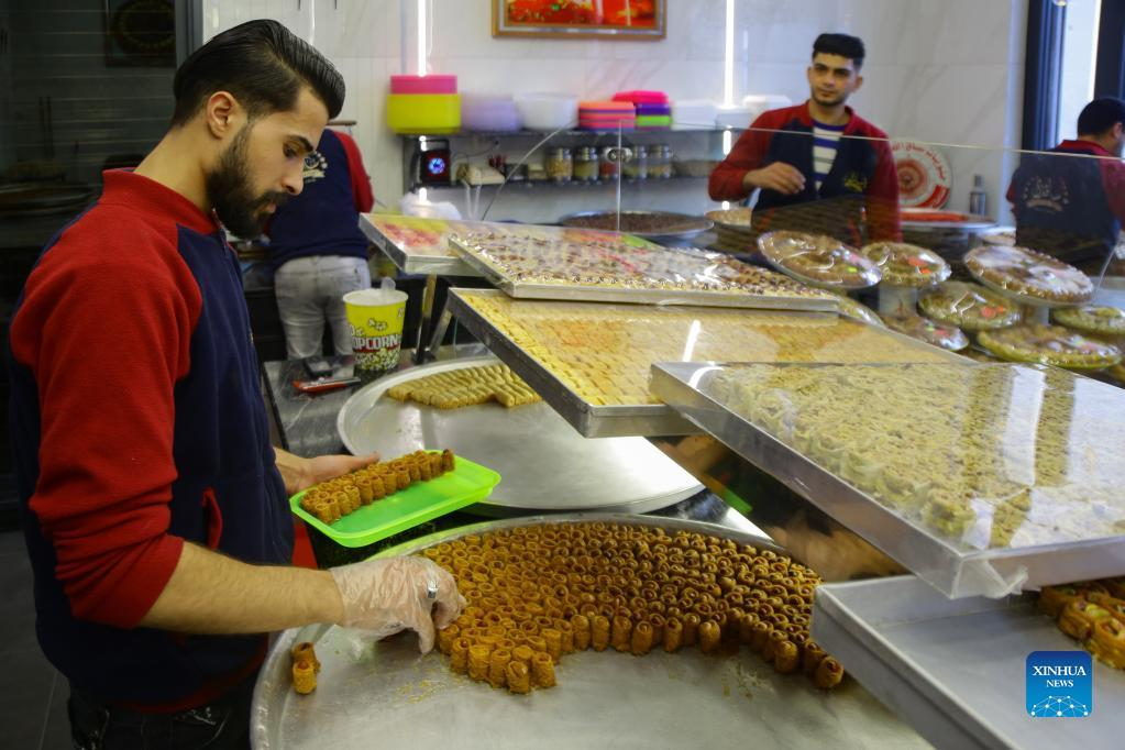 Staff members prepare traditional sweets during holy month of Ramadan ...