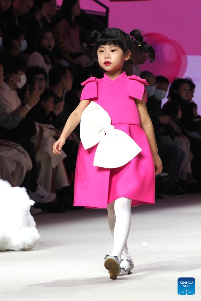 Young models present creations during Shanghai Fashion Week-Xinhua