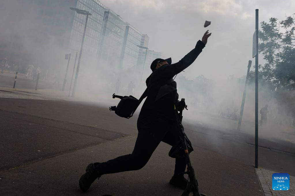 Protesters clash with riot officers at march for killed teenager in ...