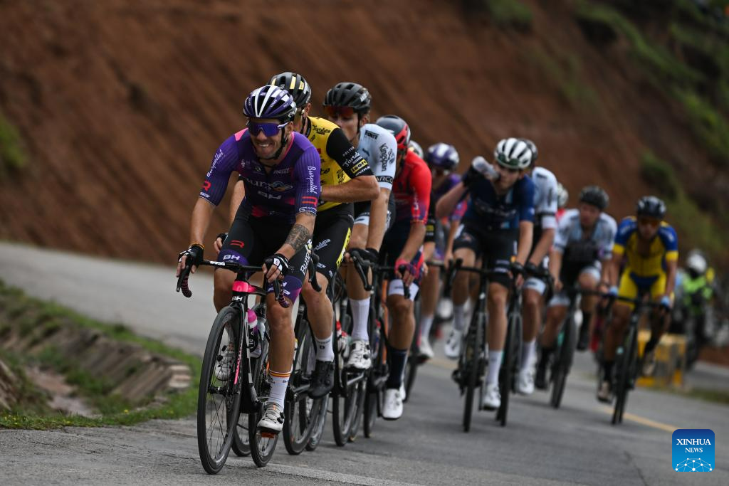 Riders compete during 22nd Tour of Qinghai Lake cycling race-Xinhua