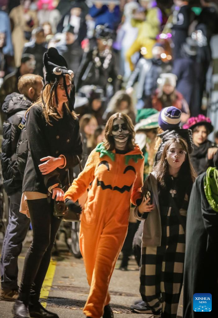 People in costume participate in parade to celebrate Halloween in ...