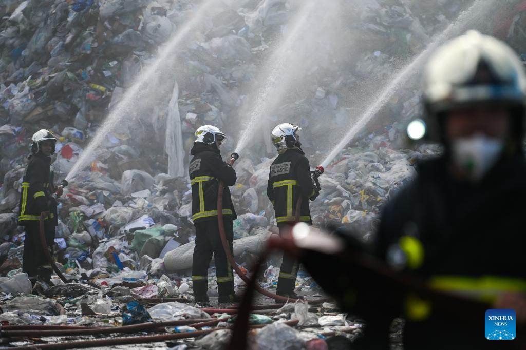 Firefighters work to extinguish fire at waste management complex in ...