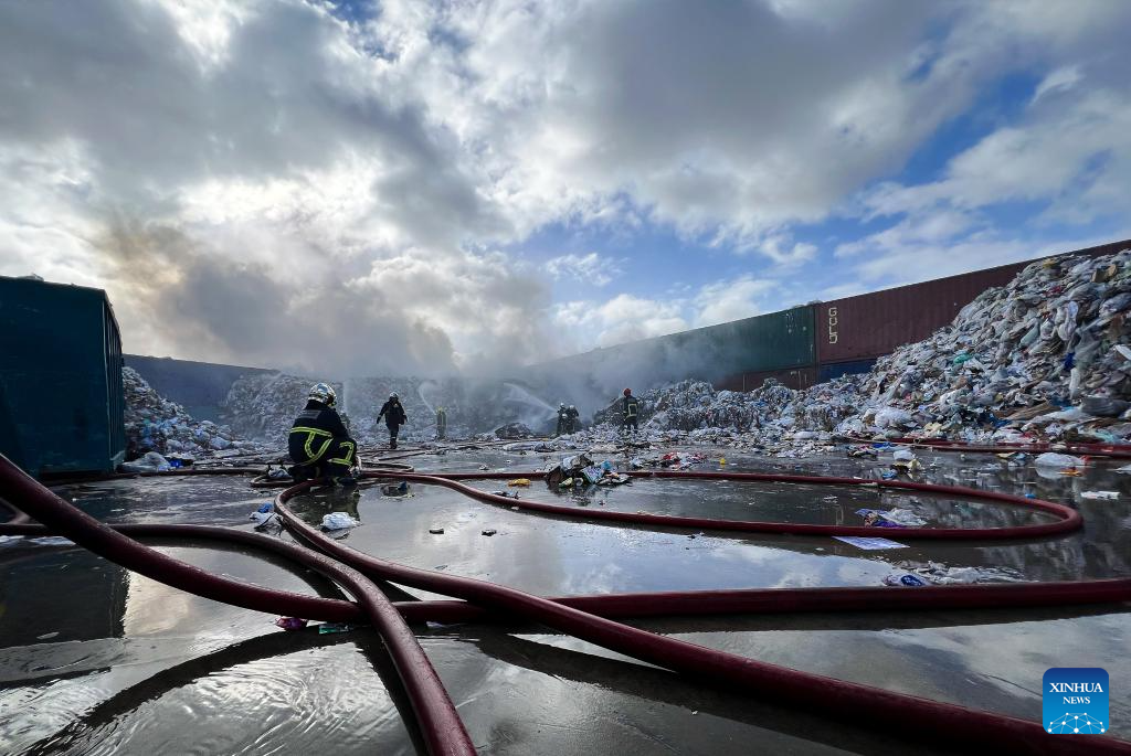 Firefighters work to extinguish fire at waste management complex in ...