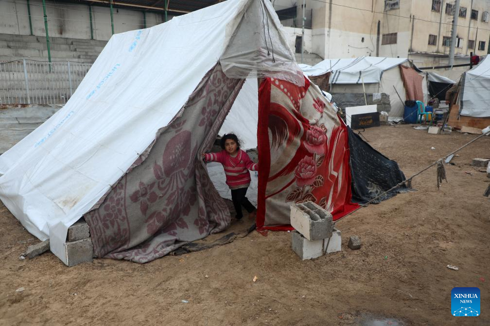 Palestinian children seen next to temporary shelters in Gaza City -Xinhua