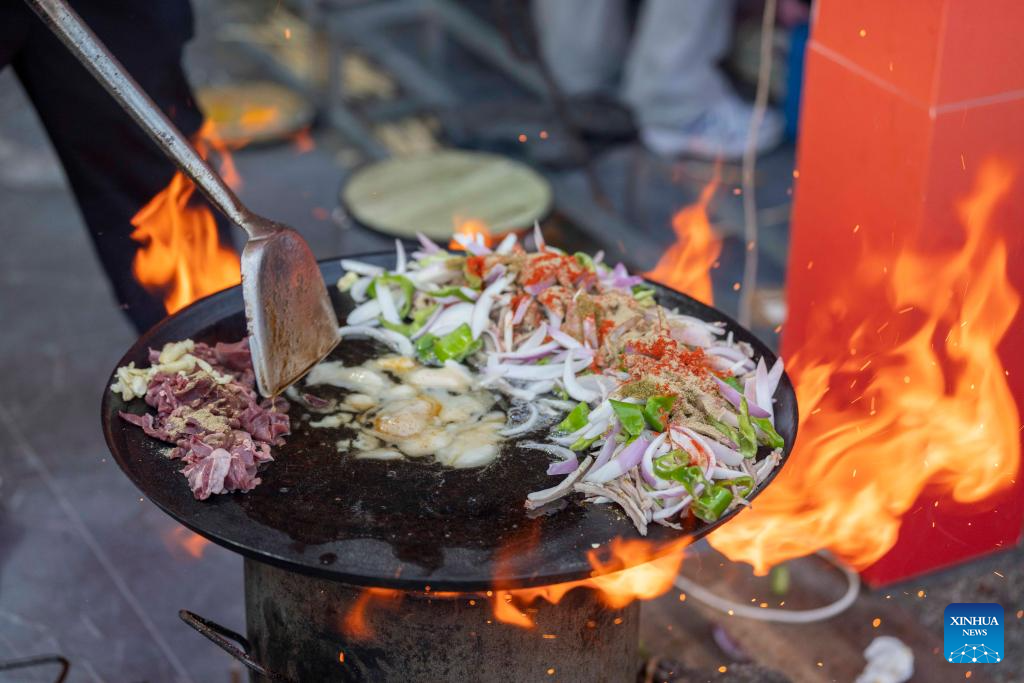 Street food Chaobola showed at food festival in Zhangye, NW China
