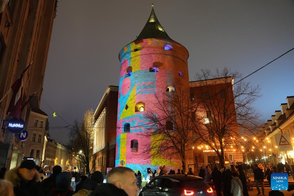 People view light show during light festival "Staro Riga 2025" in ...