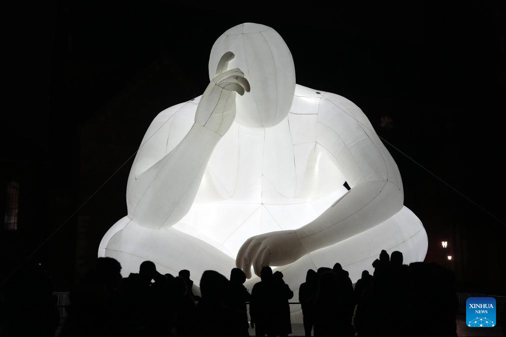 People view light show during light festival "Staro Riga 2025" in ...