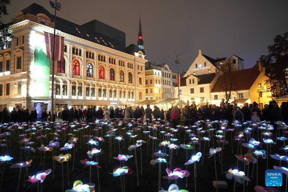 People view light show during light festival "Staro Riga 2025" in ...
