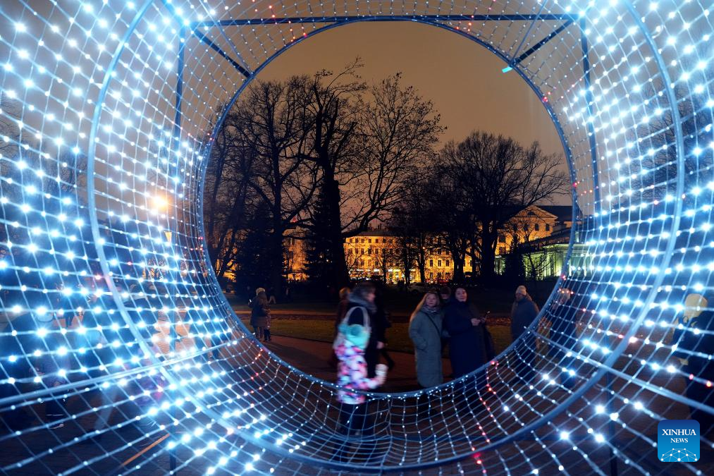 People view light show during light festival "Staro Riga 2025" in ...