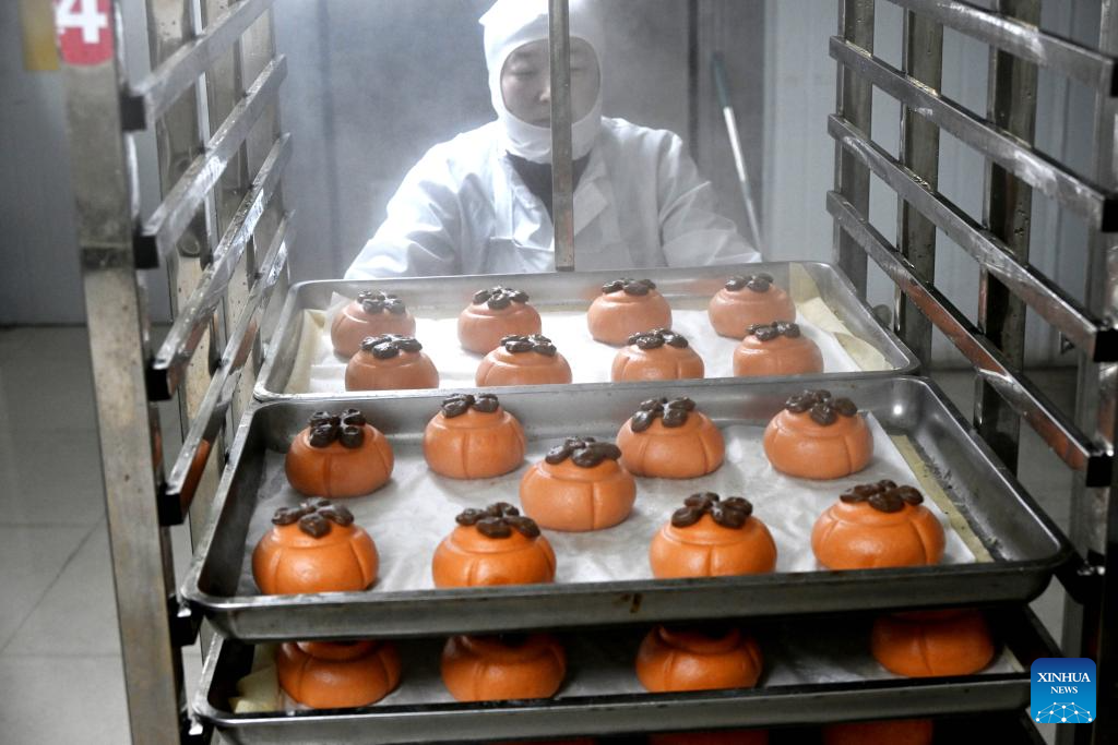 Staff members prepare flour products for Spring Festival in China's ...