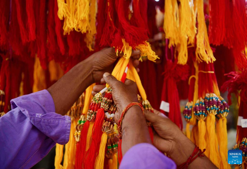 Customers buy "Rakhi" sacred threads for Raksha Bandhan festival in ...