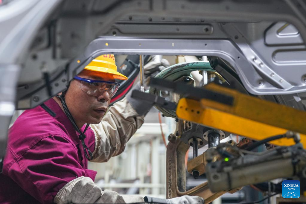 Employees busy working on truck assembly line at production base in ...