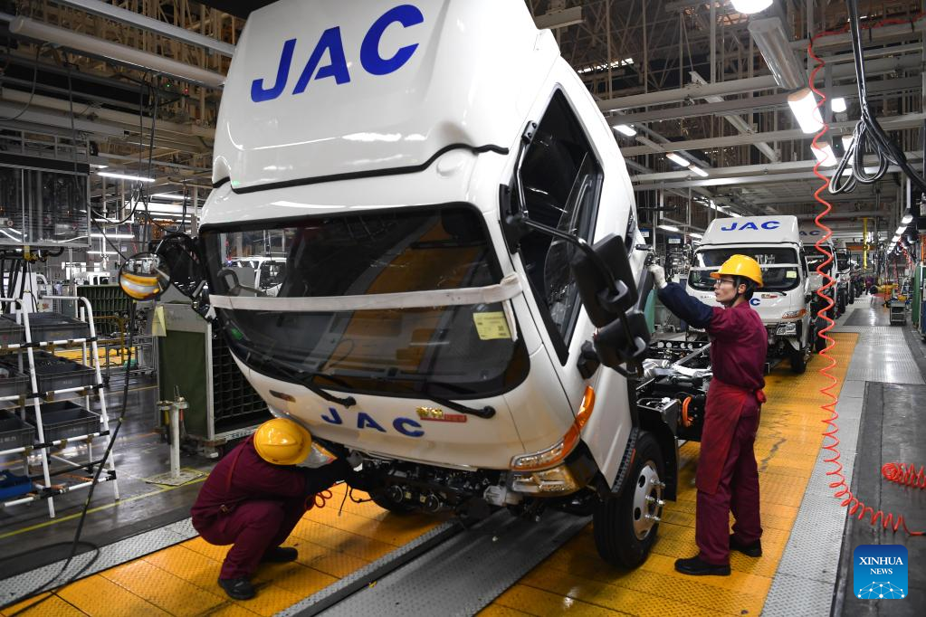 Employees busy working on truck assembly line at production base in ...