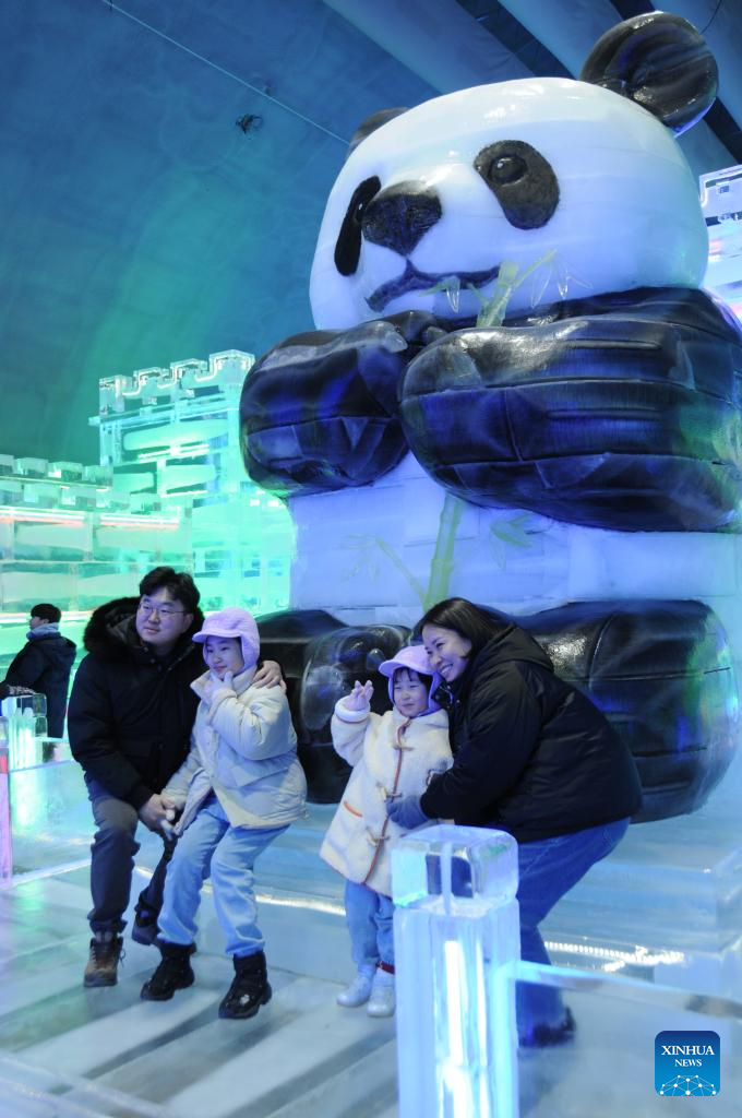 Tourists view ice statues made by Chinese ice sculptors in Gangwon ...