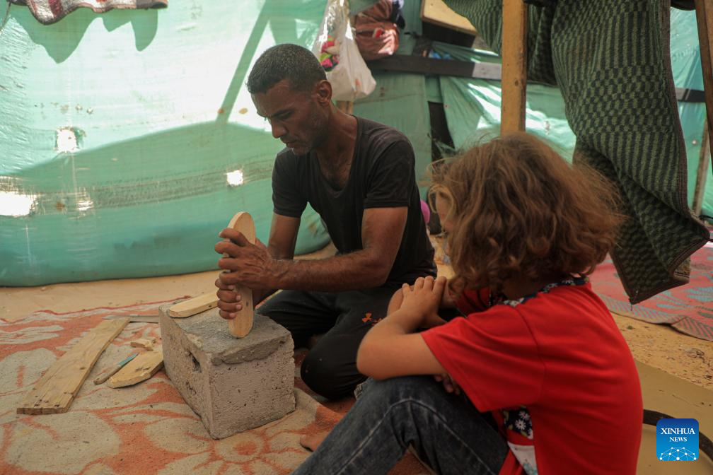 Feature: Palestinian carpenter makes wooden slippers for displaced ...